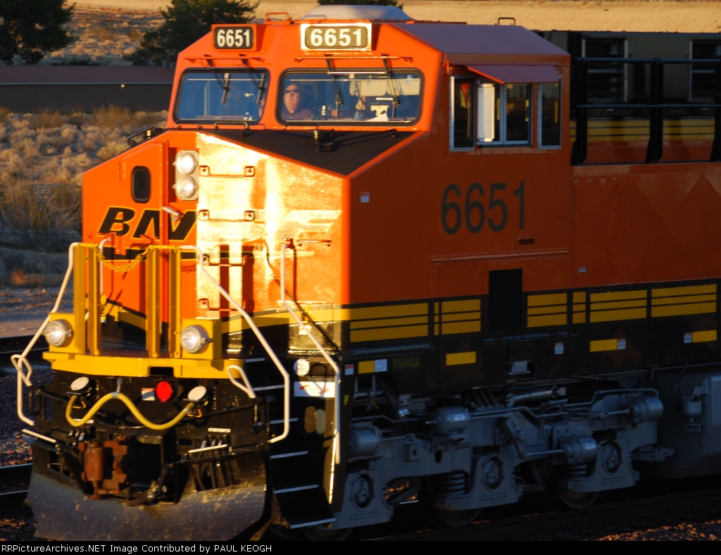 Close in shot of the Crew of BNSF 6651 as they pull west into the setting sun on Halloween.